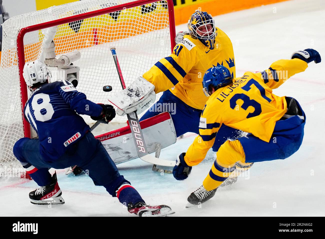 Sweden's goalie Lars Johansson, top, saves a shot by France's Dylan ...