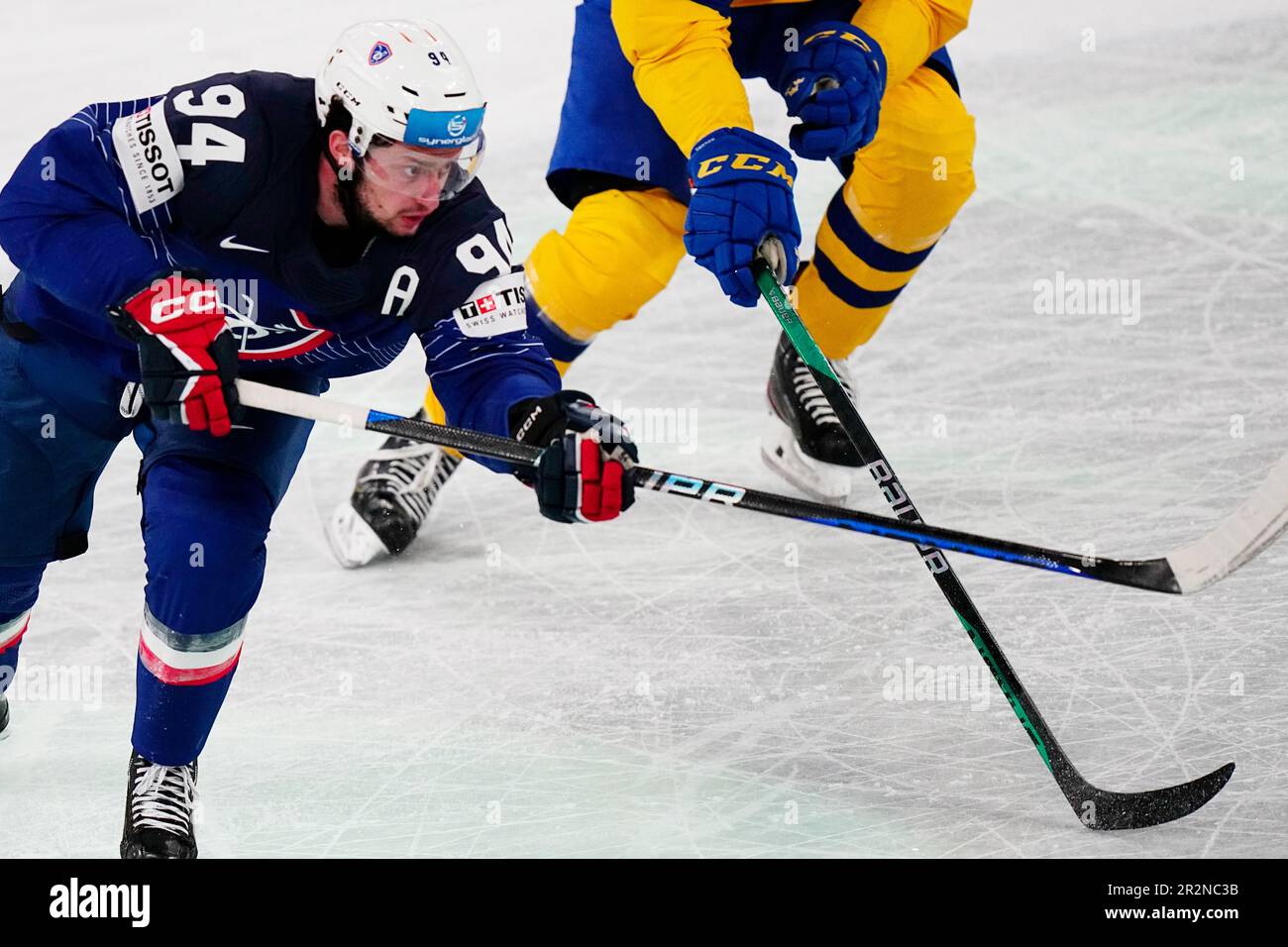 France's Tim Bozon, left, shoots the puck during the group A match ...