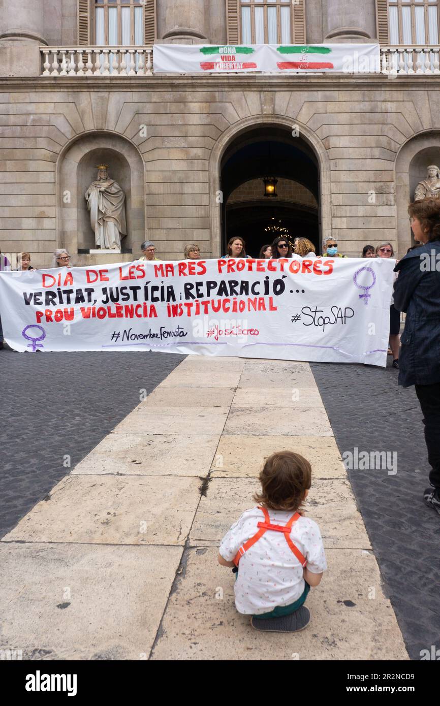 A child watches as a feminist group protests women's/mother's rights in ...