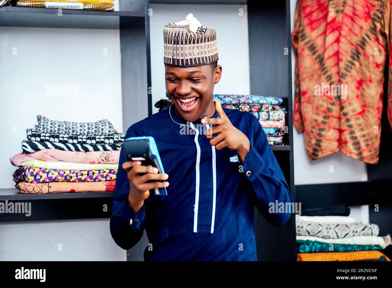 Photo of a man using a pos machine for making payment transaction in an ...