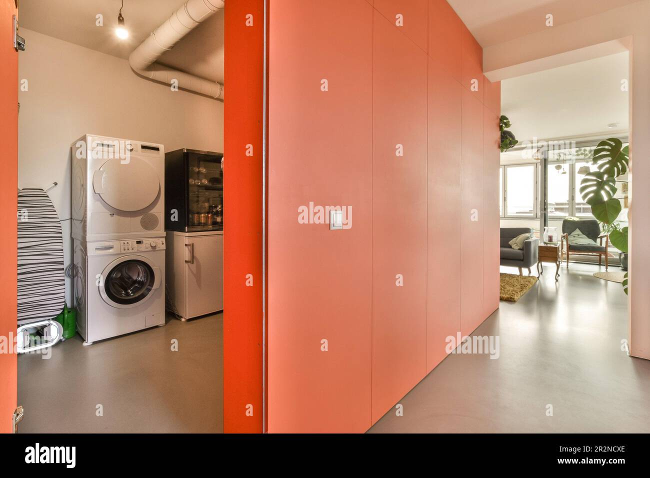 a laundry room with a washer, dryer and washing machine in the fore ...