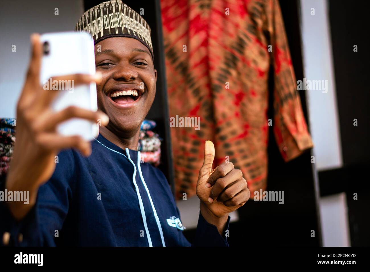Photo of a African man taking a self-portrait with his smartphone ...