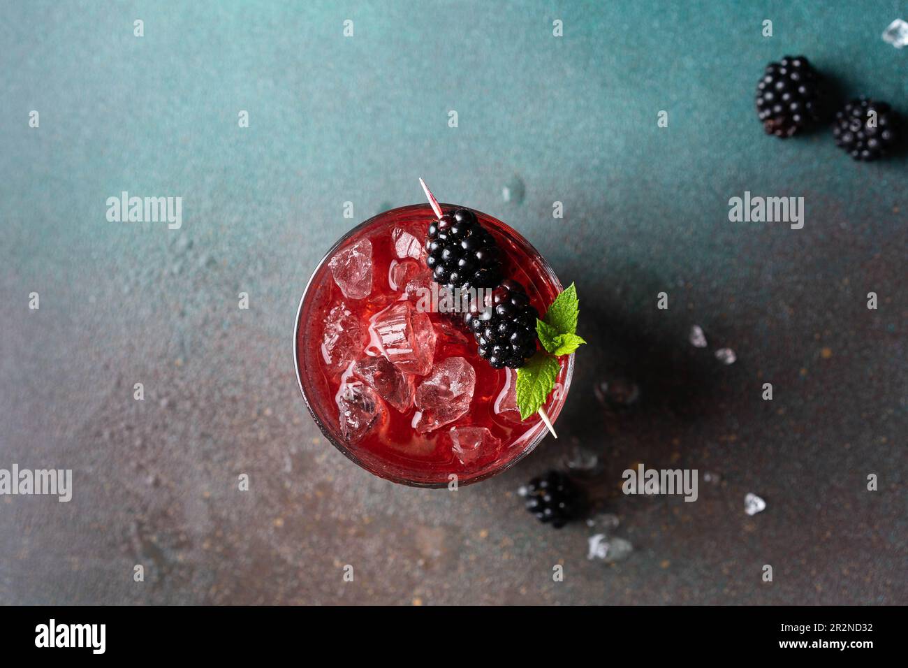 Cold berry lemonade with ice for a hot day. With a backdrop of wood and ...