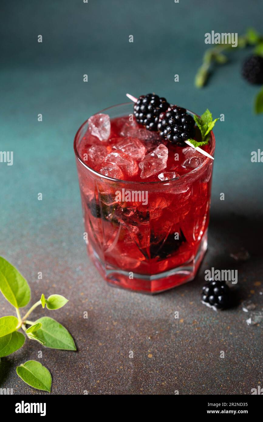 Cold berry lemonade with ice for a hot day. With a backdrop of wood and ...