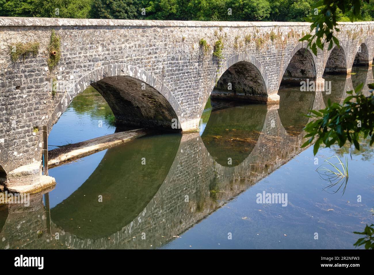 Old stone bridge on Bosherston Lily Ponds trail near Stackpole ...