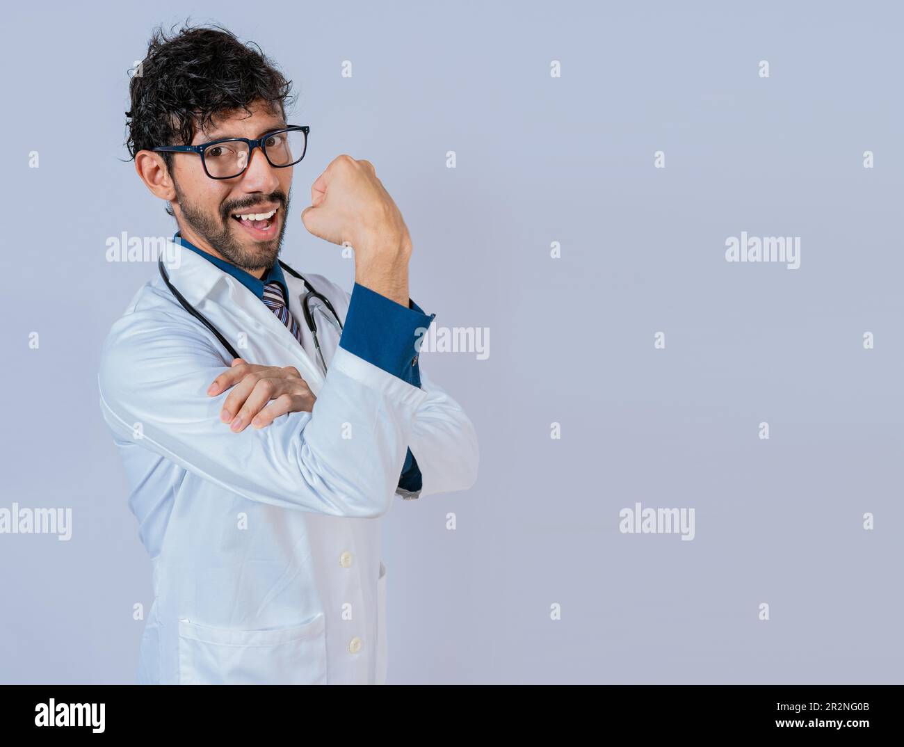 Doctor showing muscle. Young doctor showing strength with his arm Stock ...