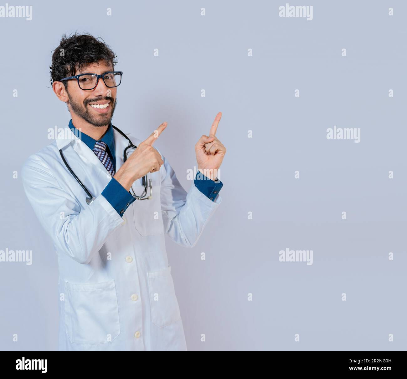 Bearded doctor pointing a promotion with finger isolated. Happy bearded ...