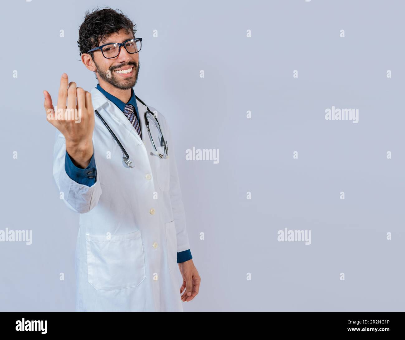 Smiling doctor inviting to come isolated. Young friendly doctor ...