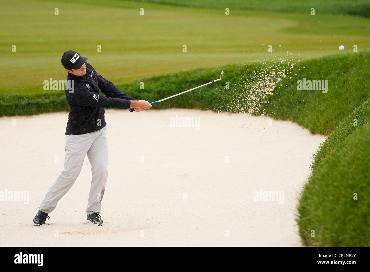 Viktor Hovland, of Norway, hits from the bunker on the fourth hole ...