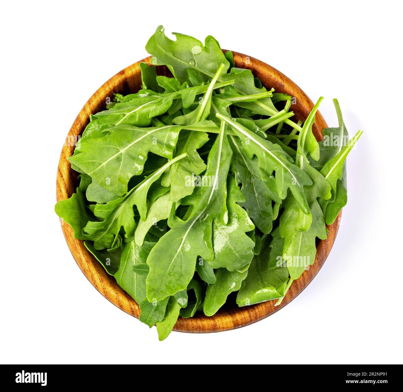 Fresh green arugula leaves on wooden bowl isolated on white background ...