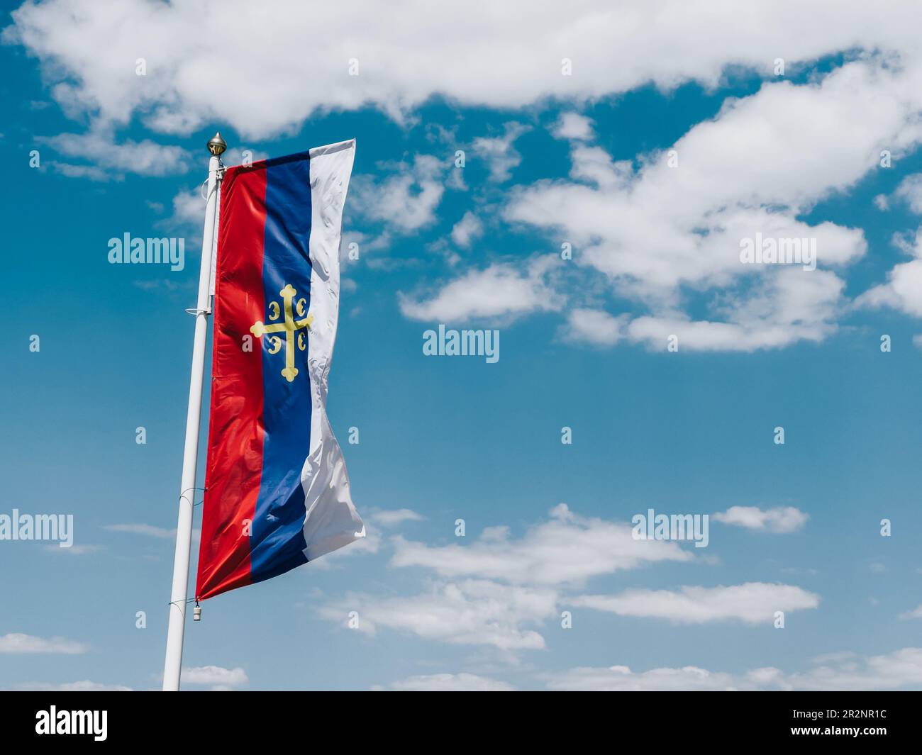 Flag of the Serbian Orthodox Church flutters on a white flagpole ...