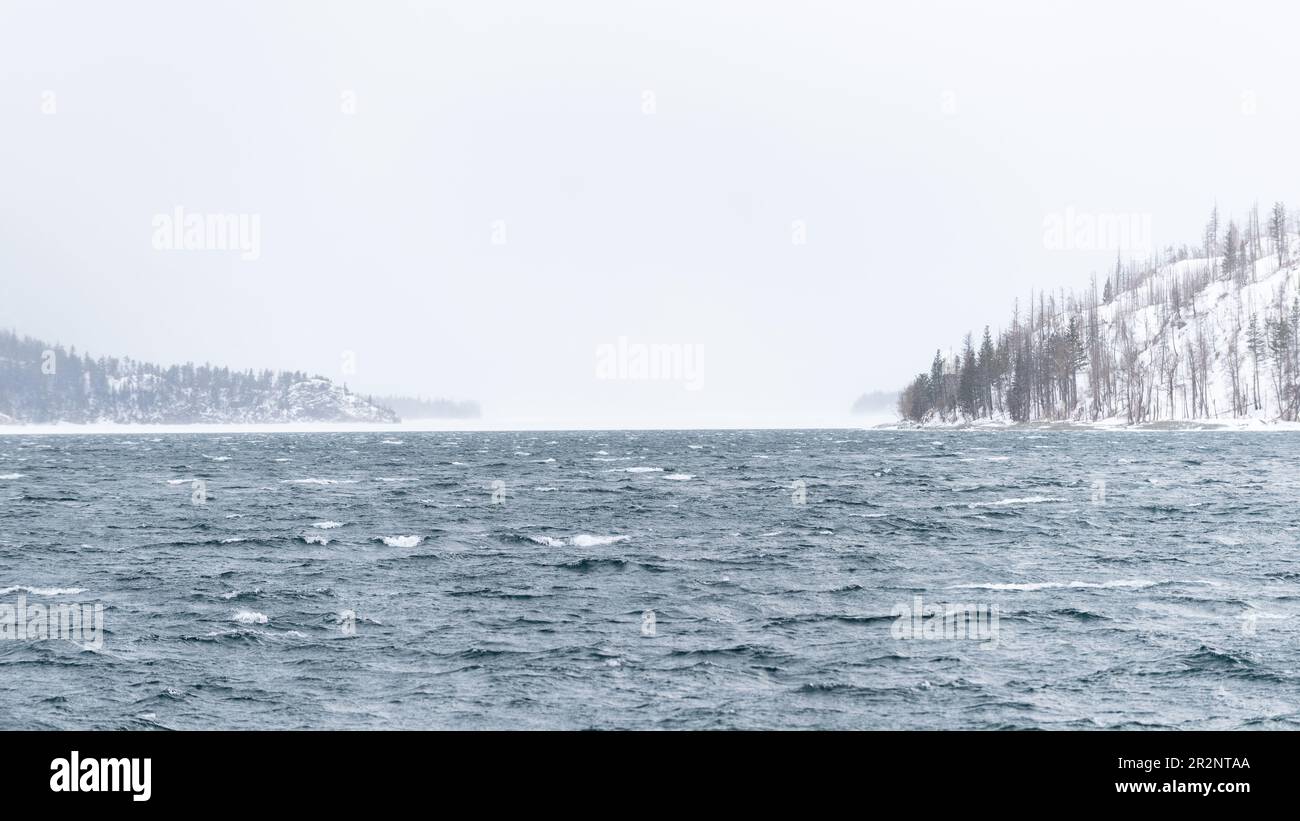 Turbulent Waterton Lake in a freezing blizzard in winter, Alberta ...