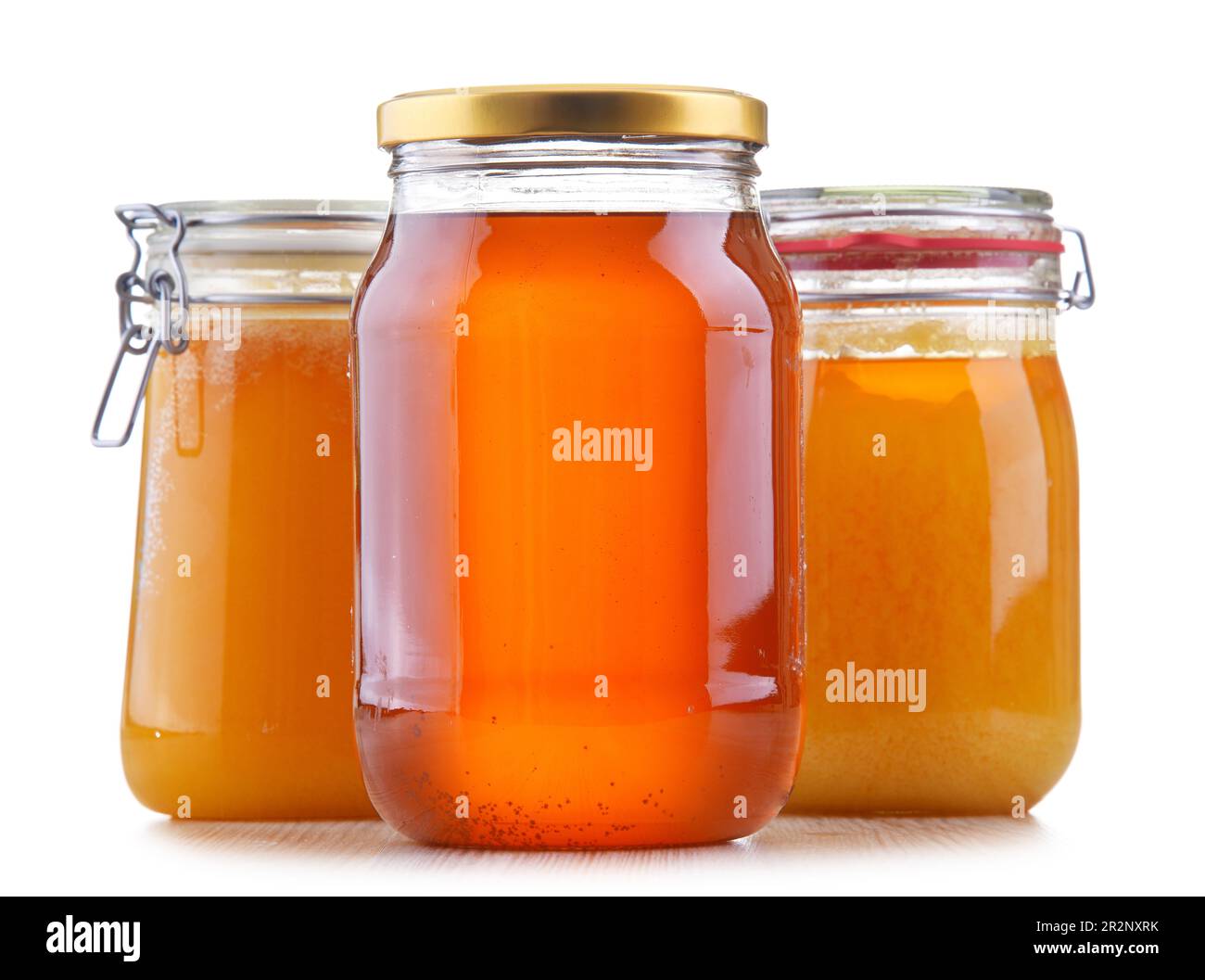 Composition with large jars of honey isolated on white Stock Photo - Alamy