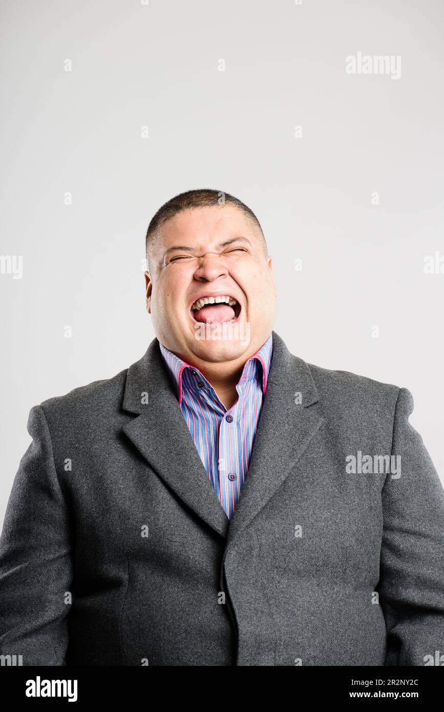 All you need is a good belly laugh. a handsome young man standing alone ...