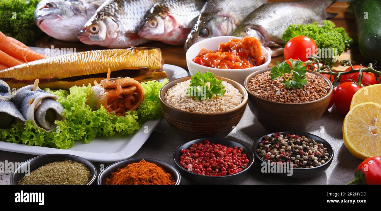 Different sorts of fish on kitchen table Stock Photo - Alamy