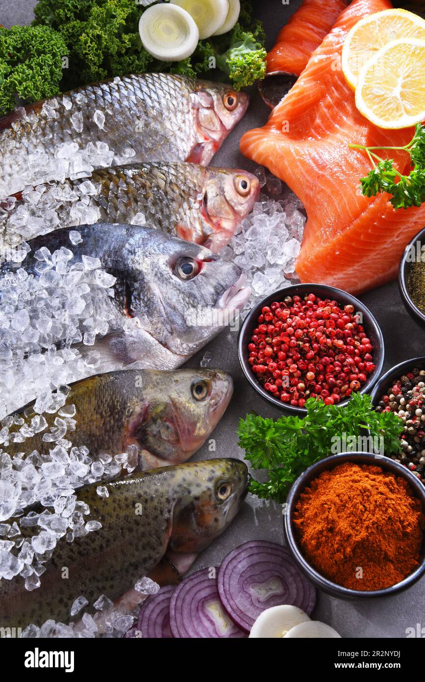 Different sorts of fish on kitchen table Stock Photo - Alamy