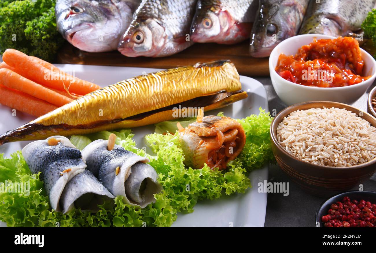 Different sorts of fish on kitchen table Stock Photo - Alamy