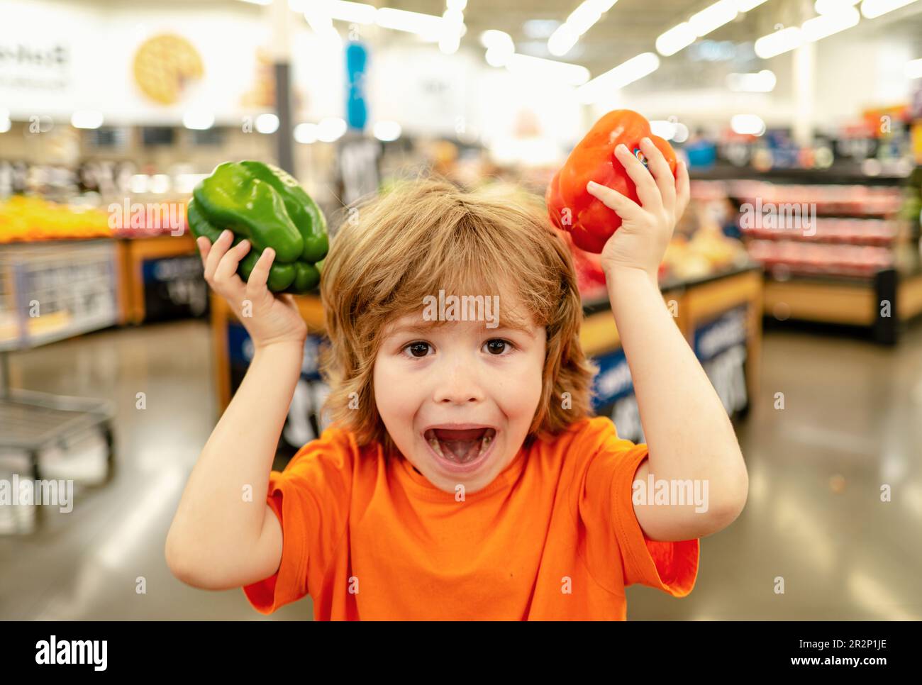 Cute toddler boy in a food store or a supermarket choosing fresh ...
