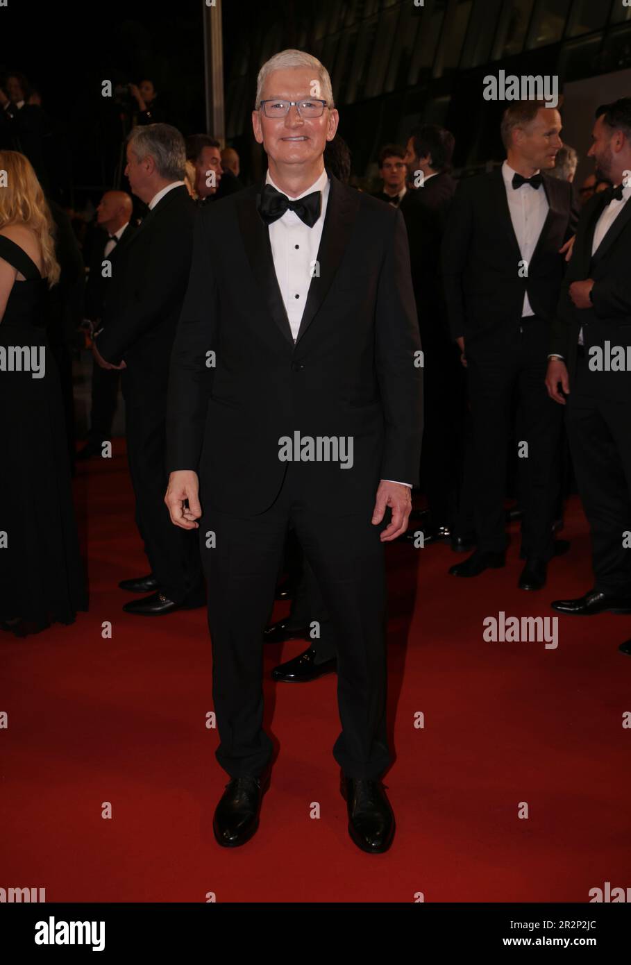 Tim Cook poses for photographers upon departure from the premiere of ...