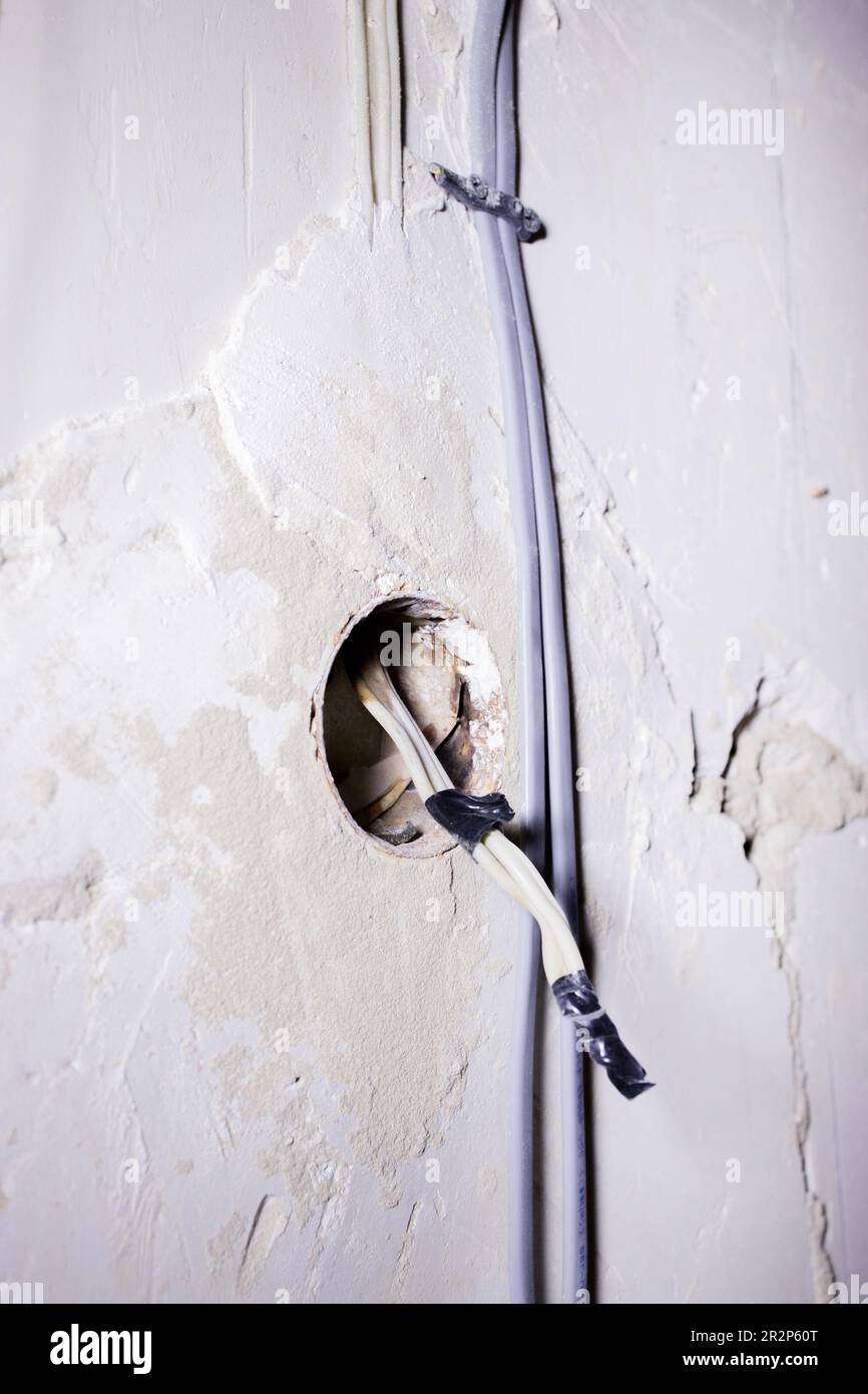 Electrical Cable laying on wall. Wiring replacement. Connecting light ...