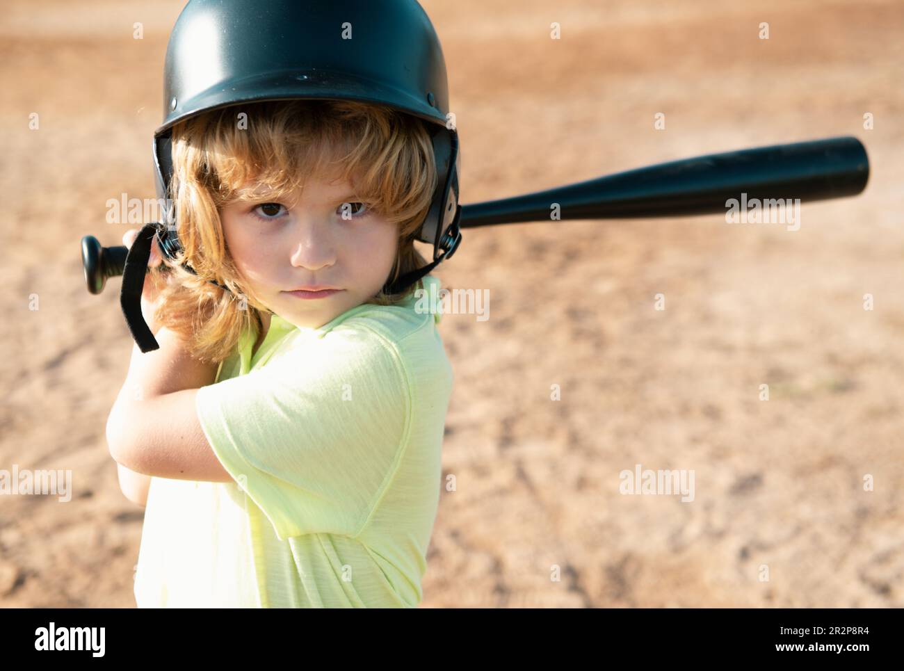 Funny kid up to bat at a baseball game. Close up child portrait Stock ...