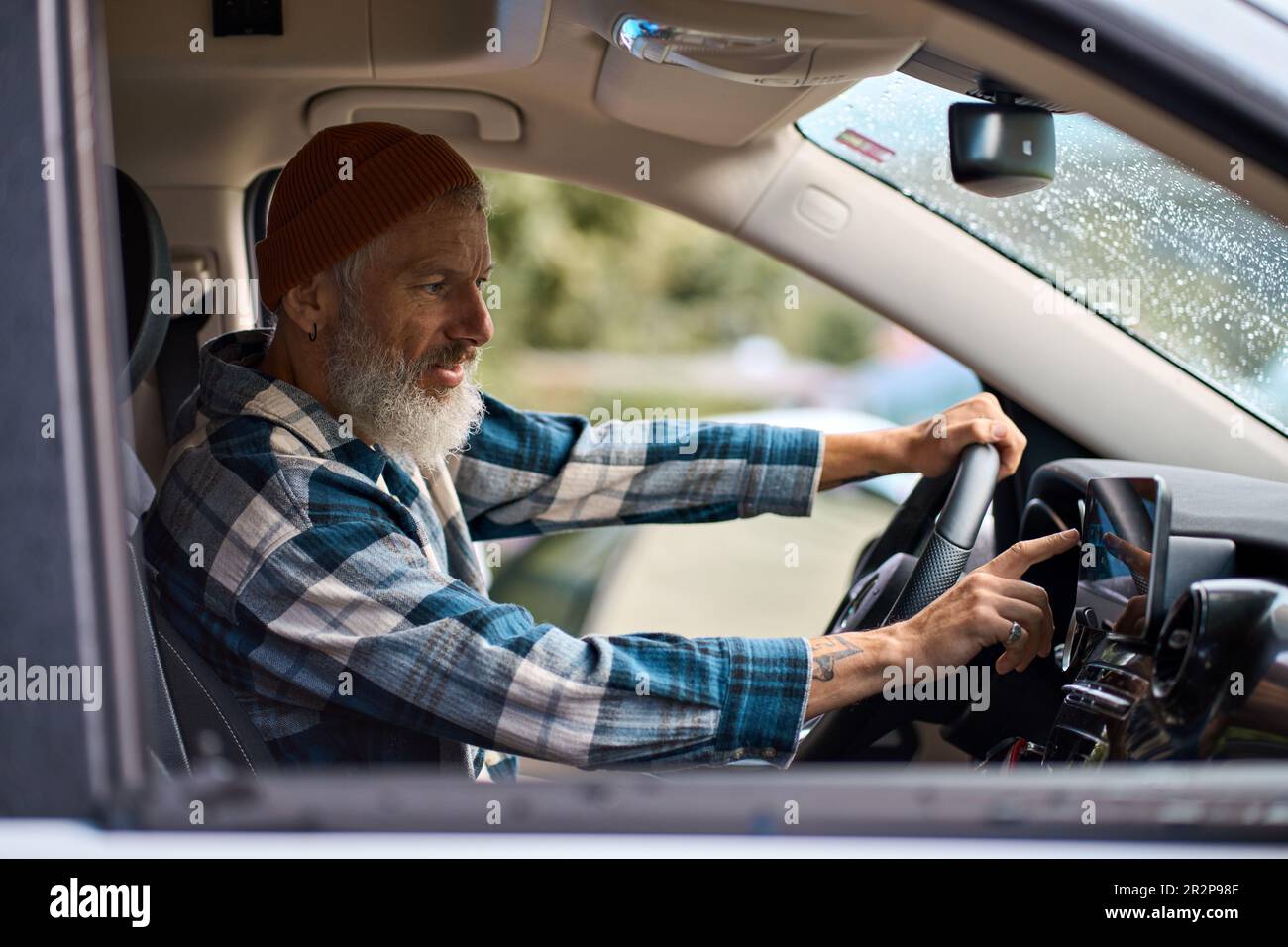 Older man traveler sitting in camper van using gps navigation driving ...