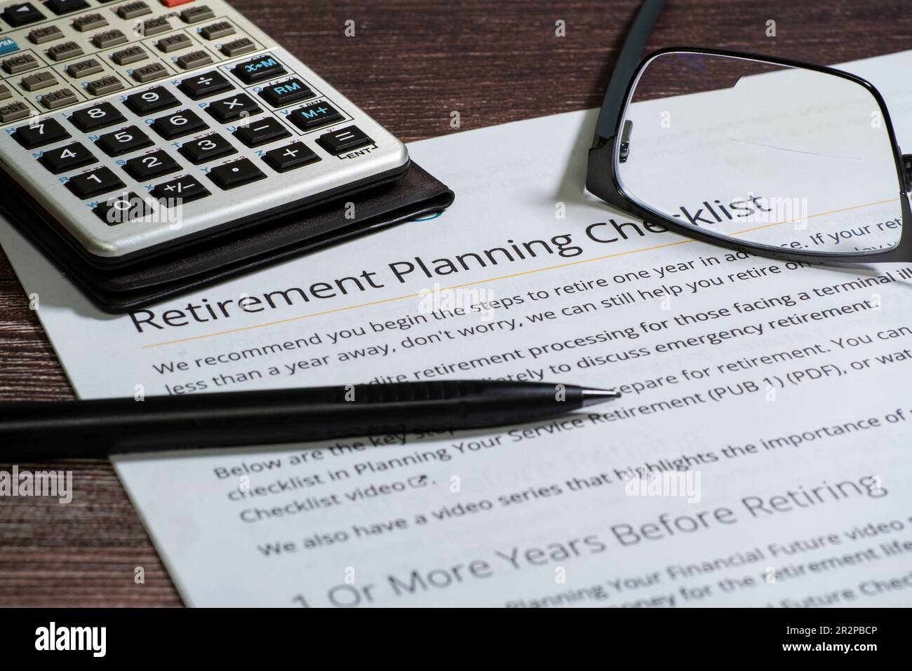 Retirement planning checklist with calculator, glasses and pencil ...