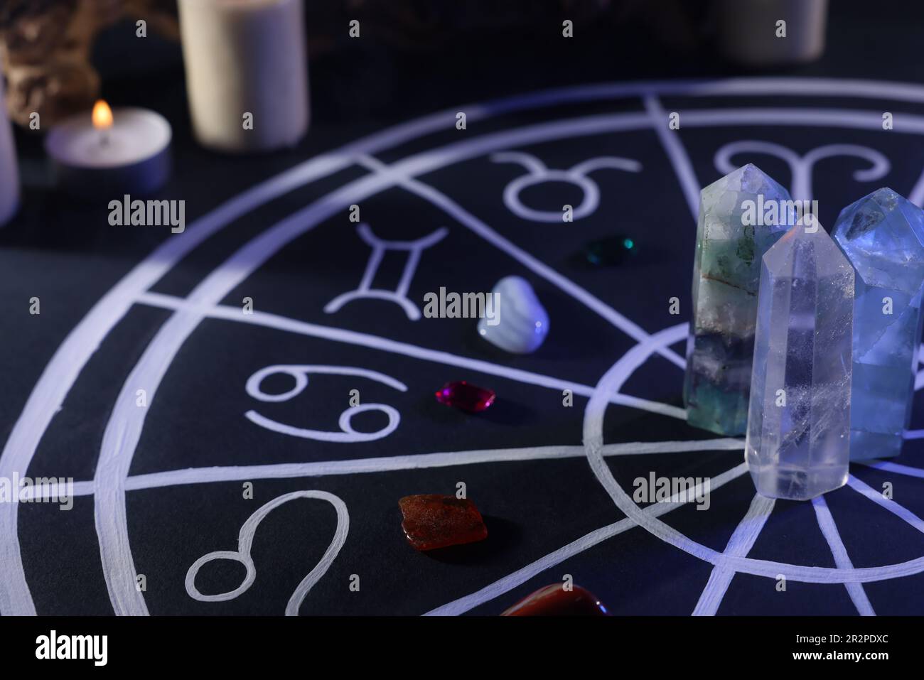 Natural stones for zodiac signs, drawn astrology chart and burning ...