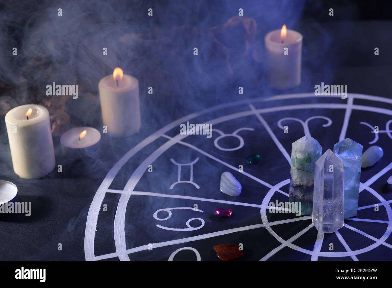 Natural stones for zodiac signs, drawn astrology chart and burning ...