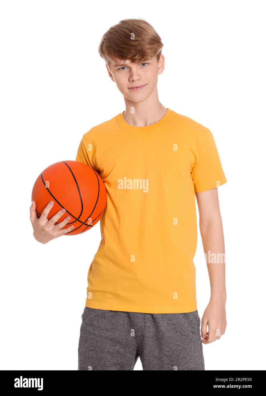 Teenage boy with basketball ball on white background Stock Photo - Alamy