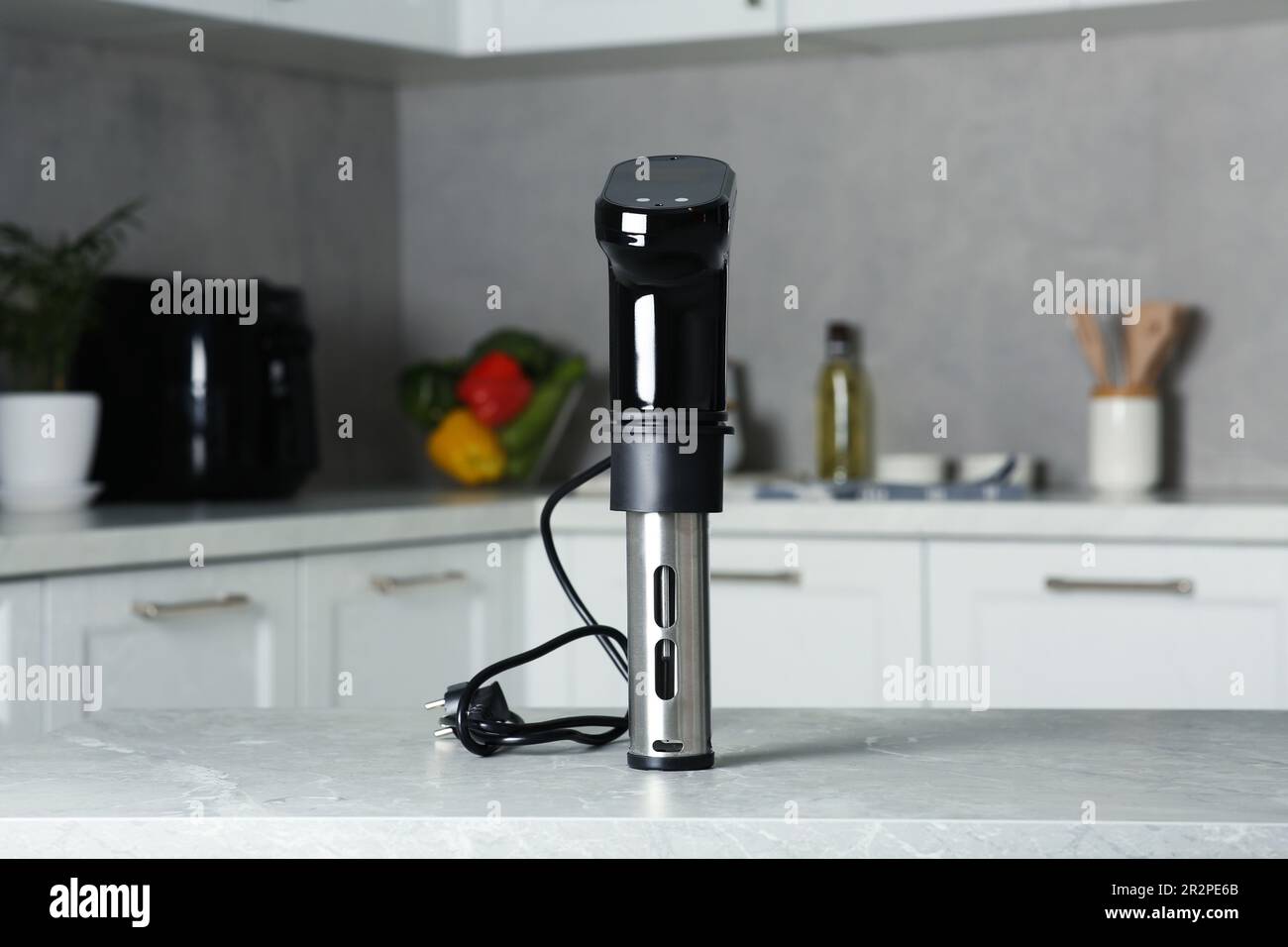 Thermal immersion circulator on table in kitchen. Sous vide cooking ...