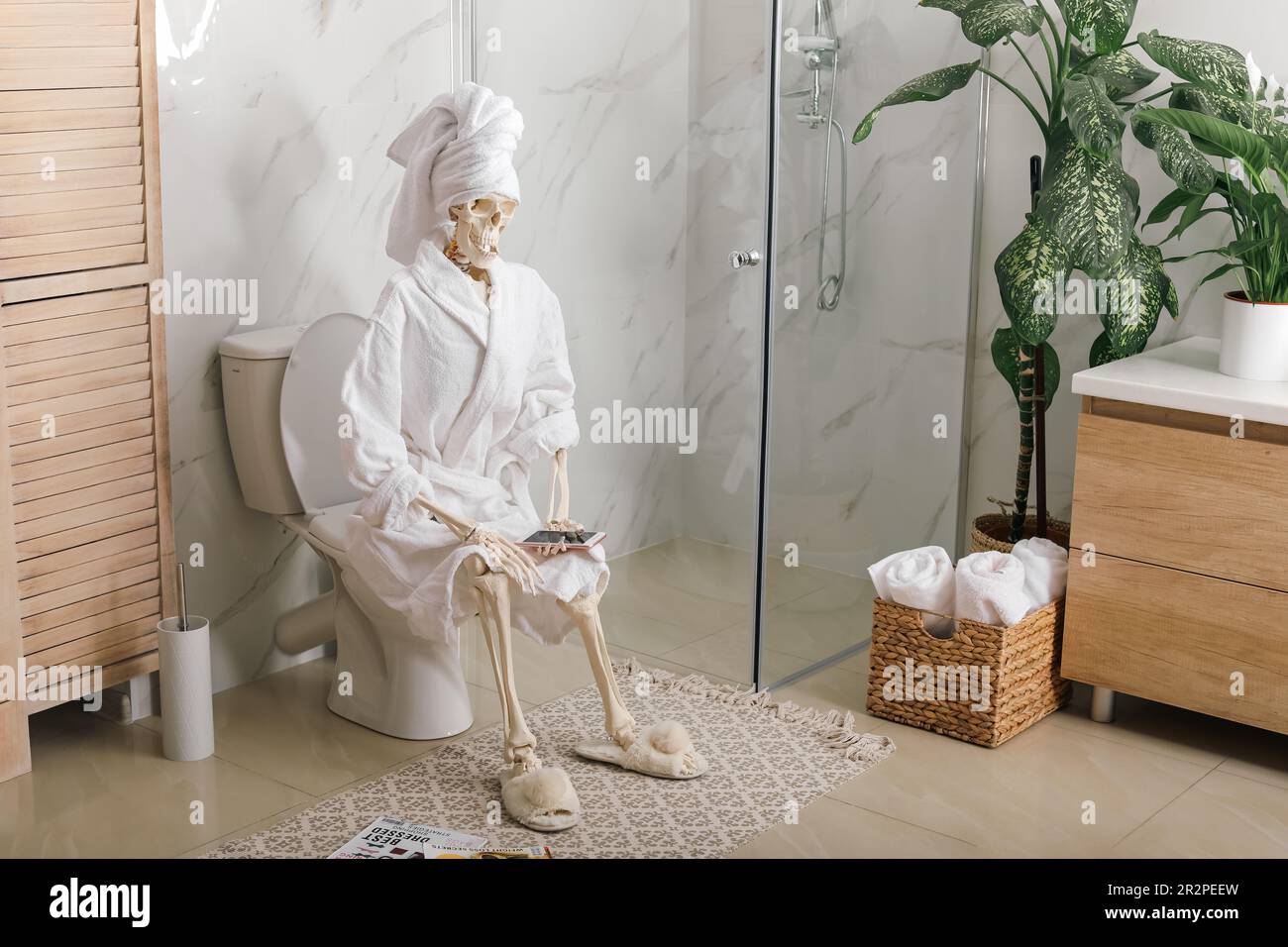 Skeleton in bathrobe with mobile phone sitting on toilet bowl Stock ...