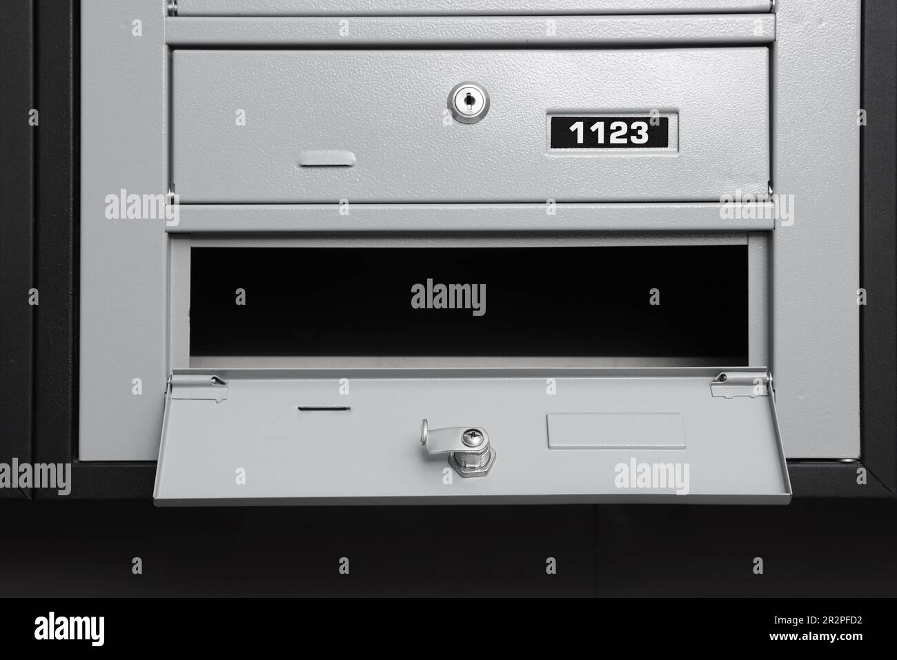Open empty grey metal mailbox with keyhole indoors Stock Photo - Alamy