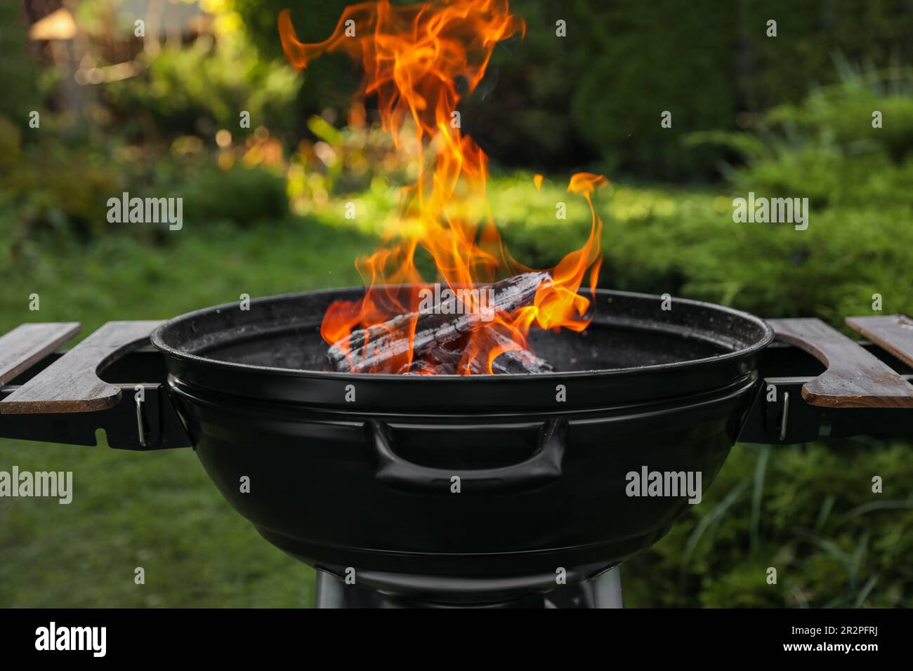 Portable barbecue grill with fire flames outdoors, closeup Stock Photo ...
