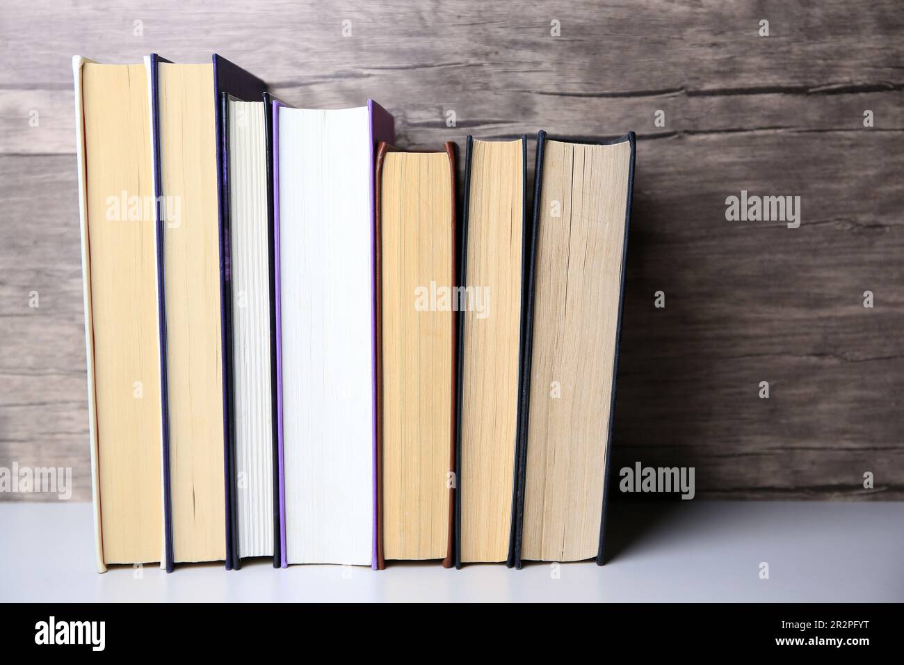 Collection of different books on white shelf, space for text Stock ...