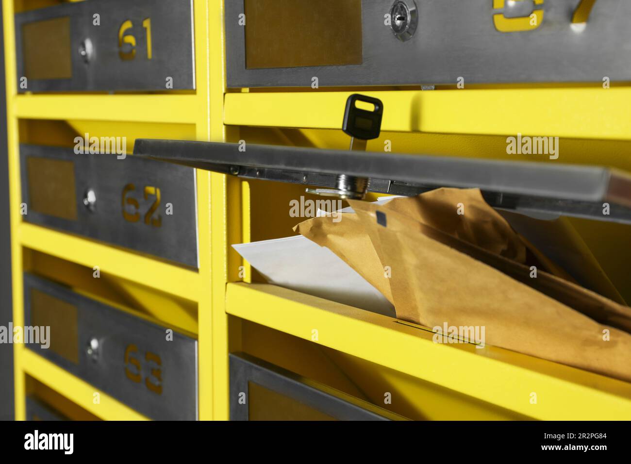 Open metal mailbox with key and correspondence, closeup Stock Photo - Alamy