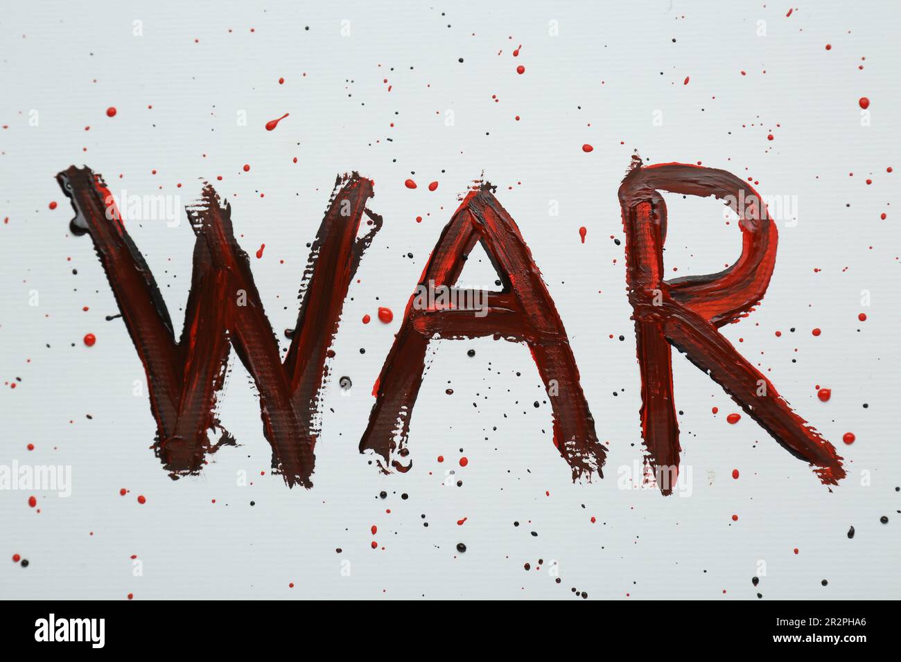Word War written with black and red paint on white background, top view ...