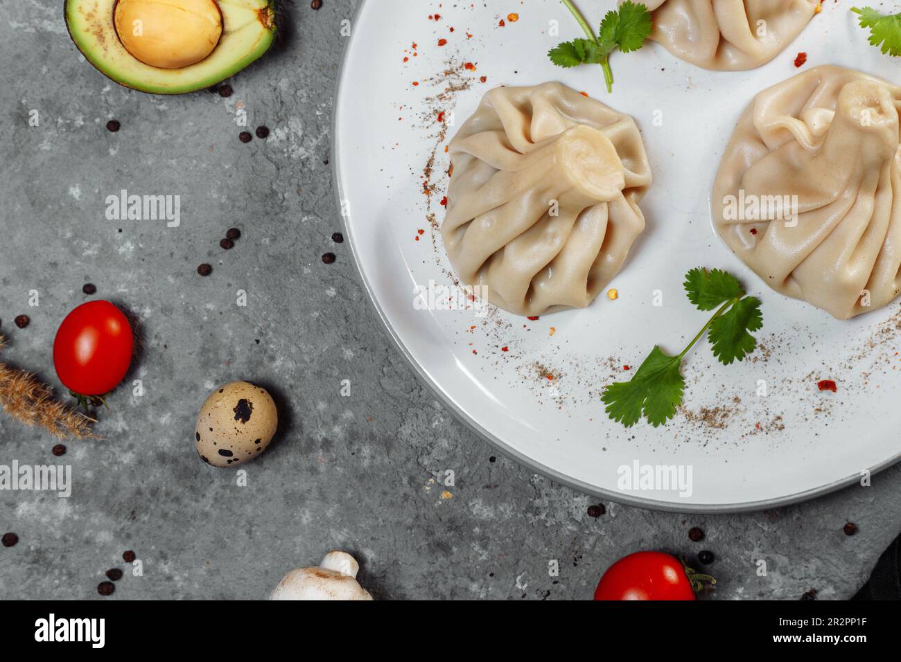 Georgian dumplings Khinkali with meat, greens and tomato spicy sauce ...
