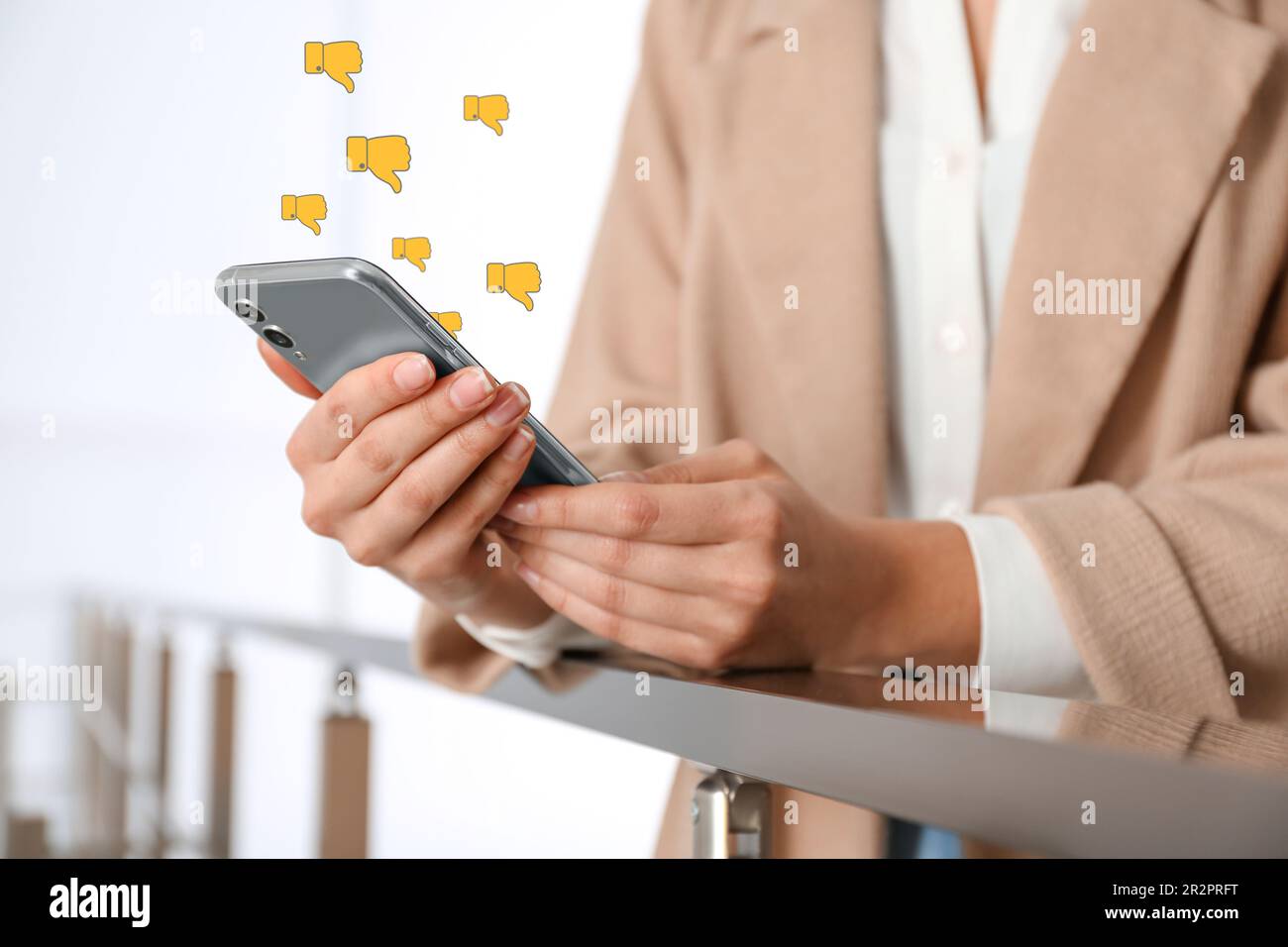 Social media dislike reaction. Woman using mobile phone indoors ...