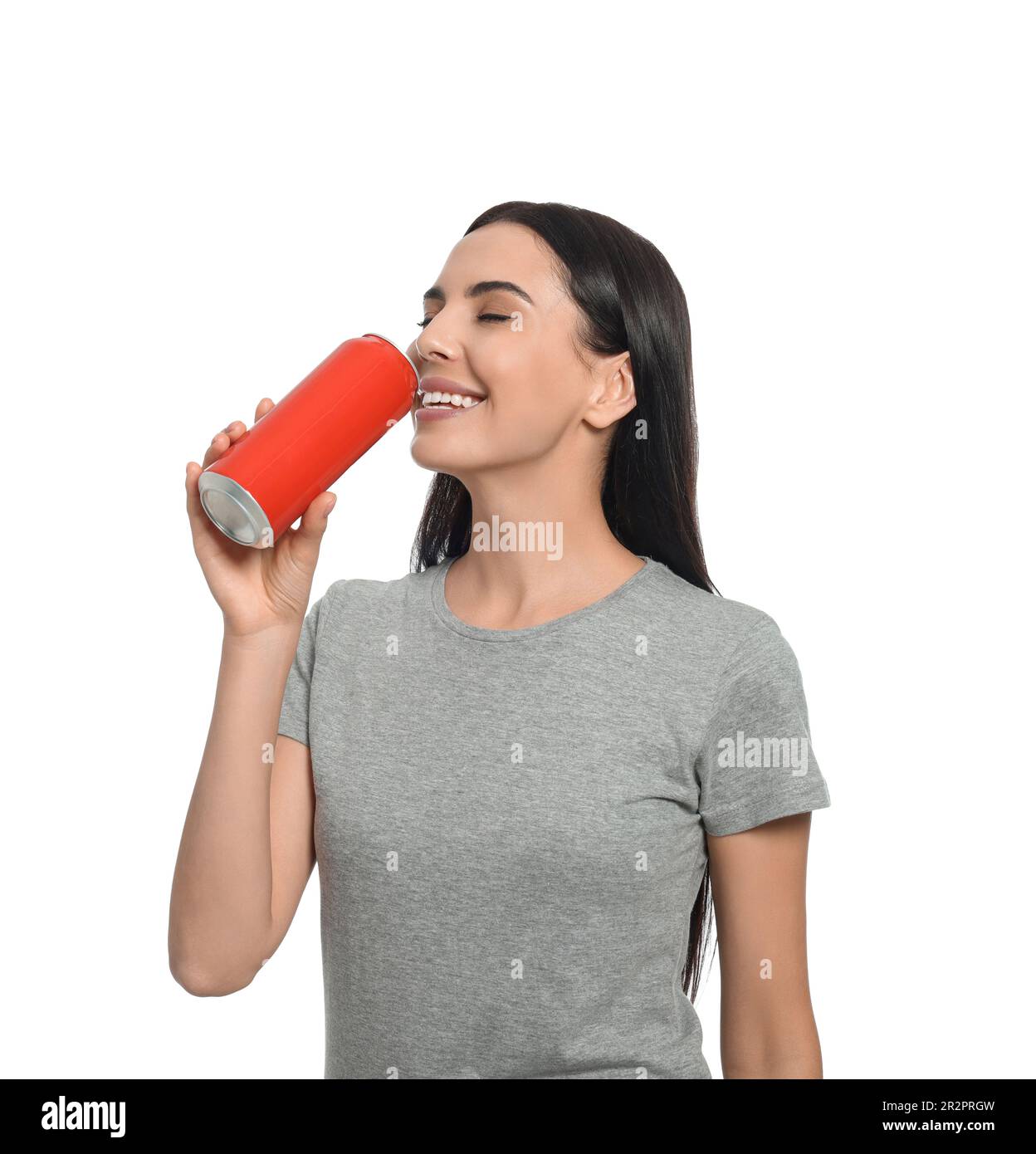 Beautiful happy woman drinking from red beverage can on white ...