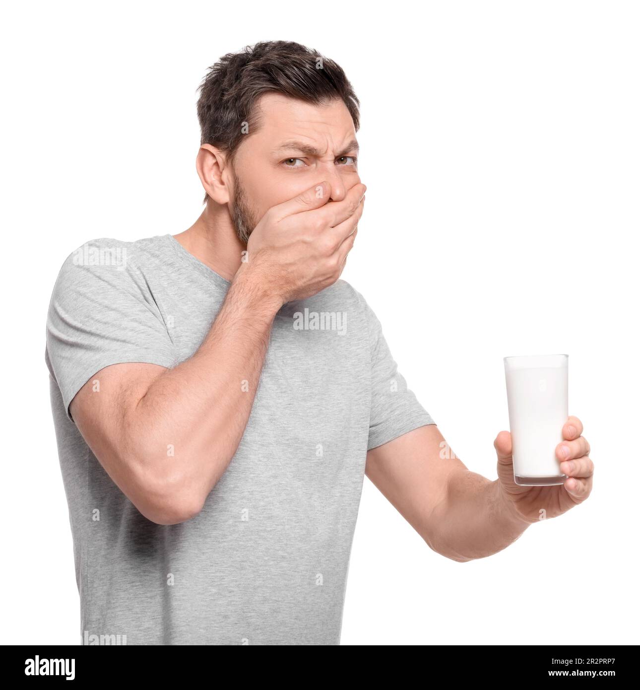 Man with glass of milk suffering from lactose intolerance on white ...