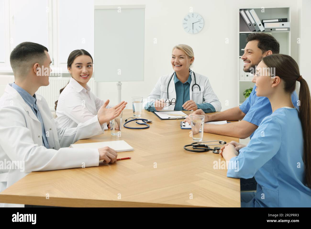 Medical conference. Team of doctors having discussion with speaker at ...