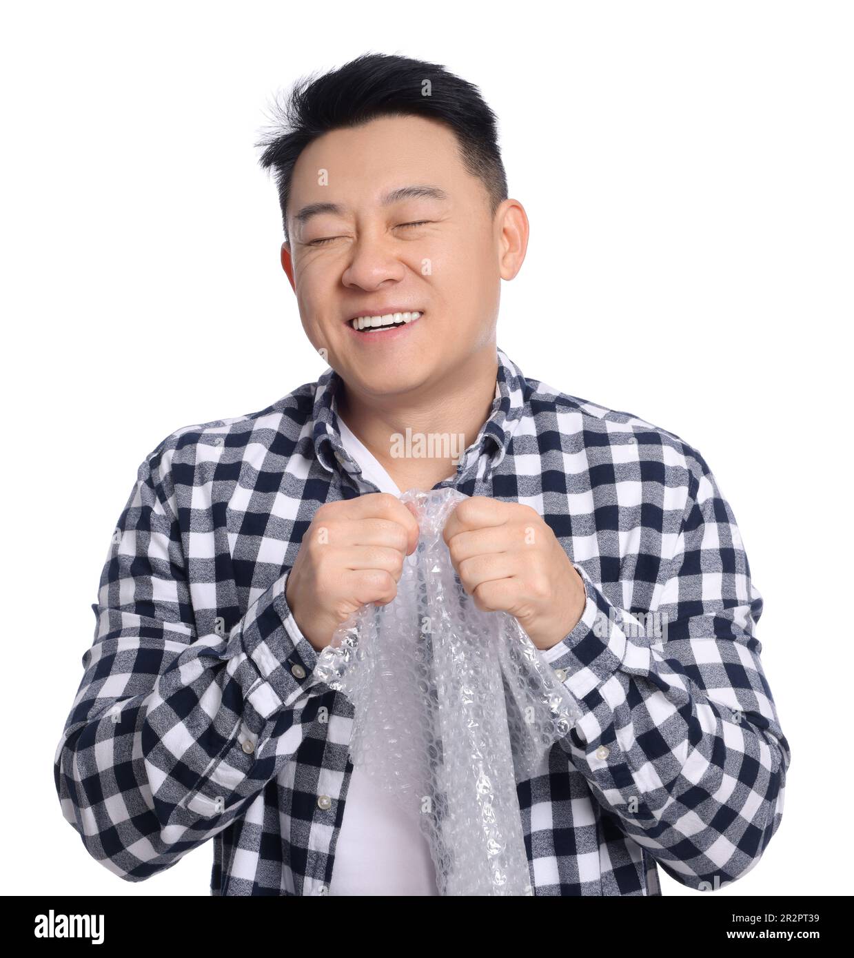 Happy asian man with bubble wrap on white background Stock Photo - Alamy