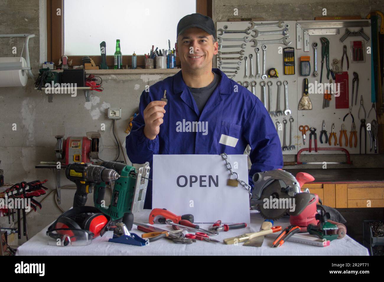 Image of a smiling handyman in his workshop with an OPEN sign and ...