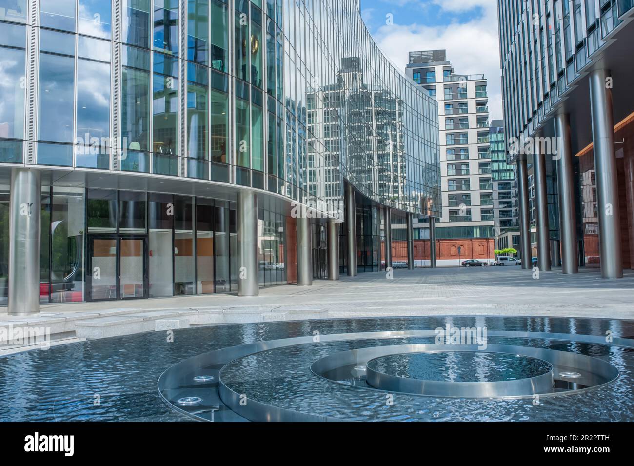 Clean water in fountain near buildings in city Stock Photo - Alamy