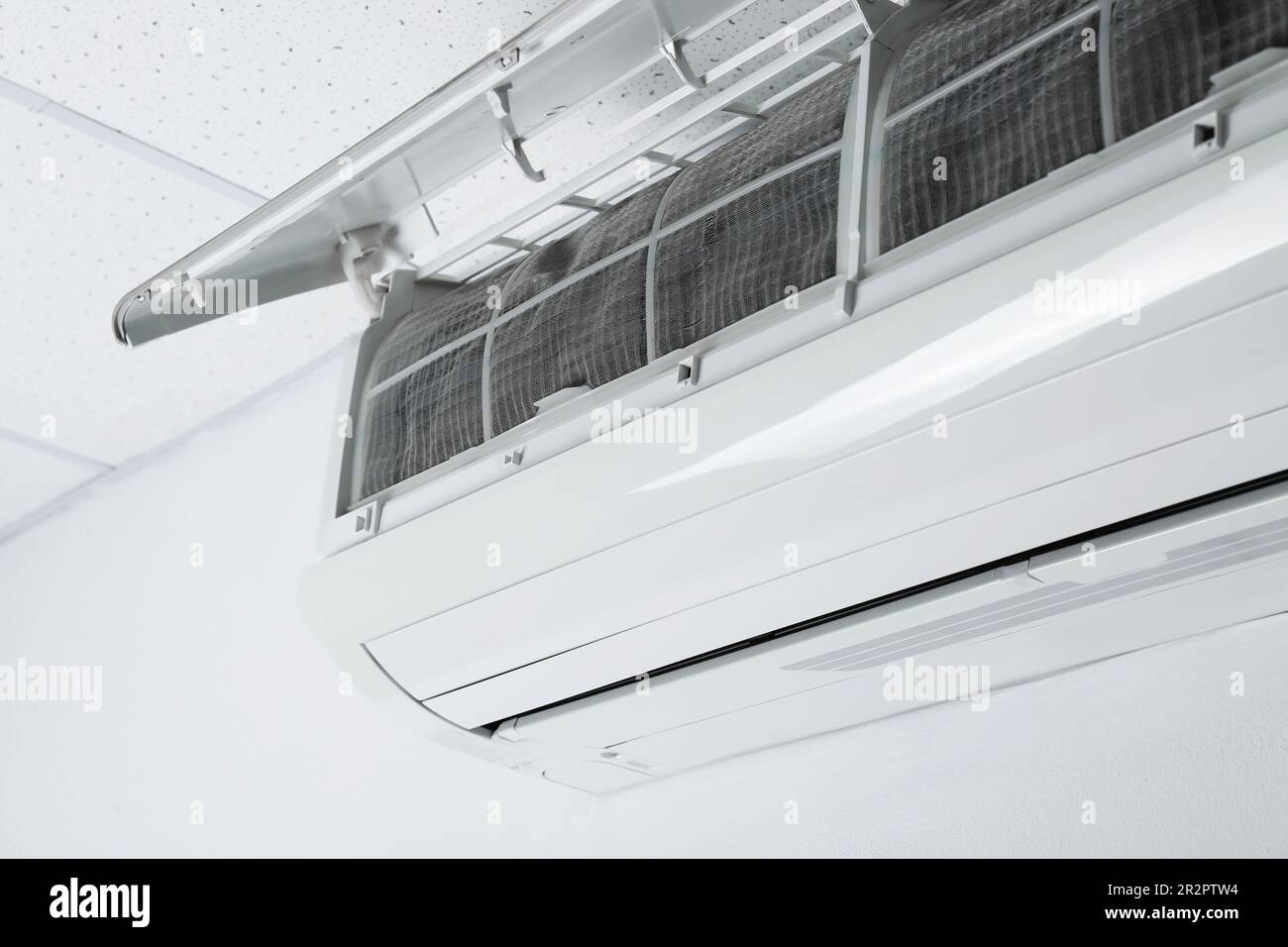 Modern air conditioner on white wall, closeup Stock Photo - Alamy
