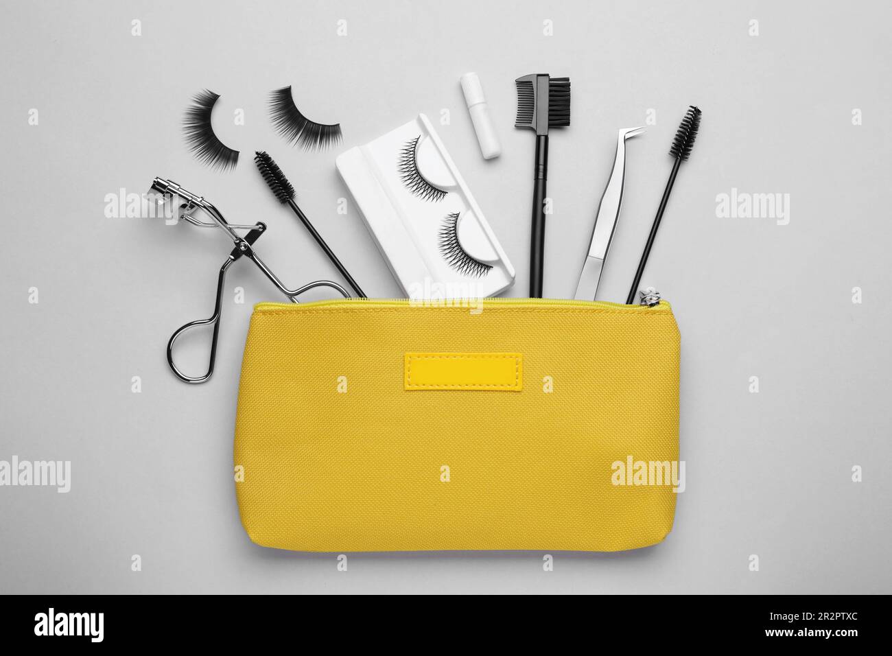 Flat lay composition with fake eyelashes, brushes and tools on light ...