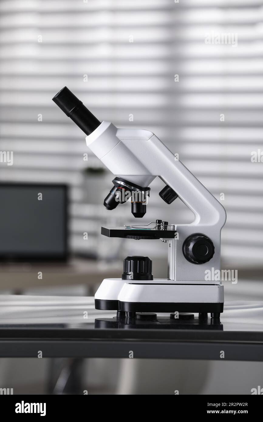 Modern medical microscope on metal table in laboratory Stock Photo - Alamy