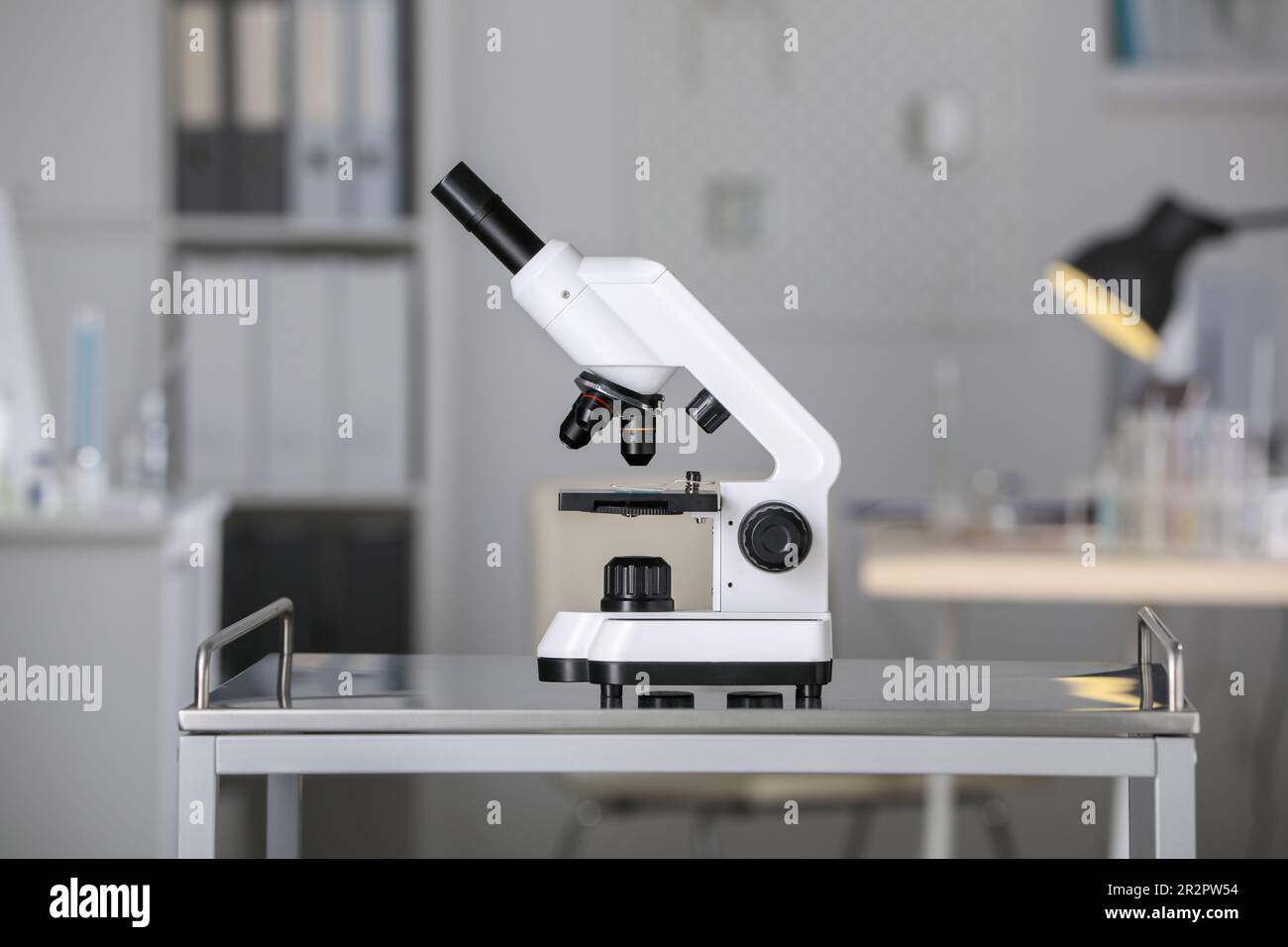Modern medical microscope on metal table in laboratory Stock Photo - Alamy