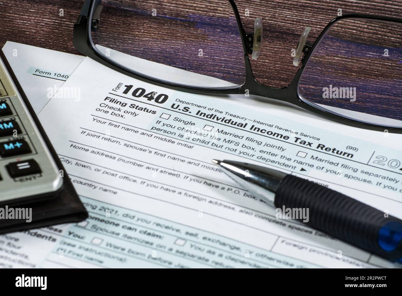 Close up of upper left corner of IRS form 1040 with eyeglasses ...